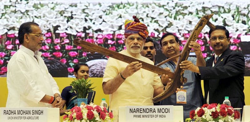 The Prime Minister, Shri Narendra Modi being presented a “Plough” as ...